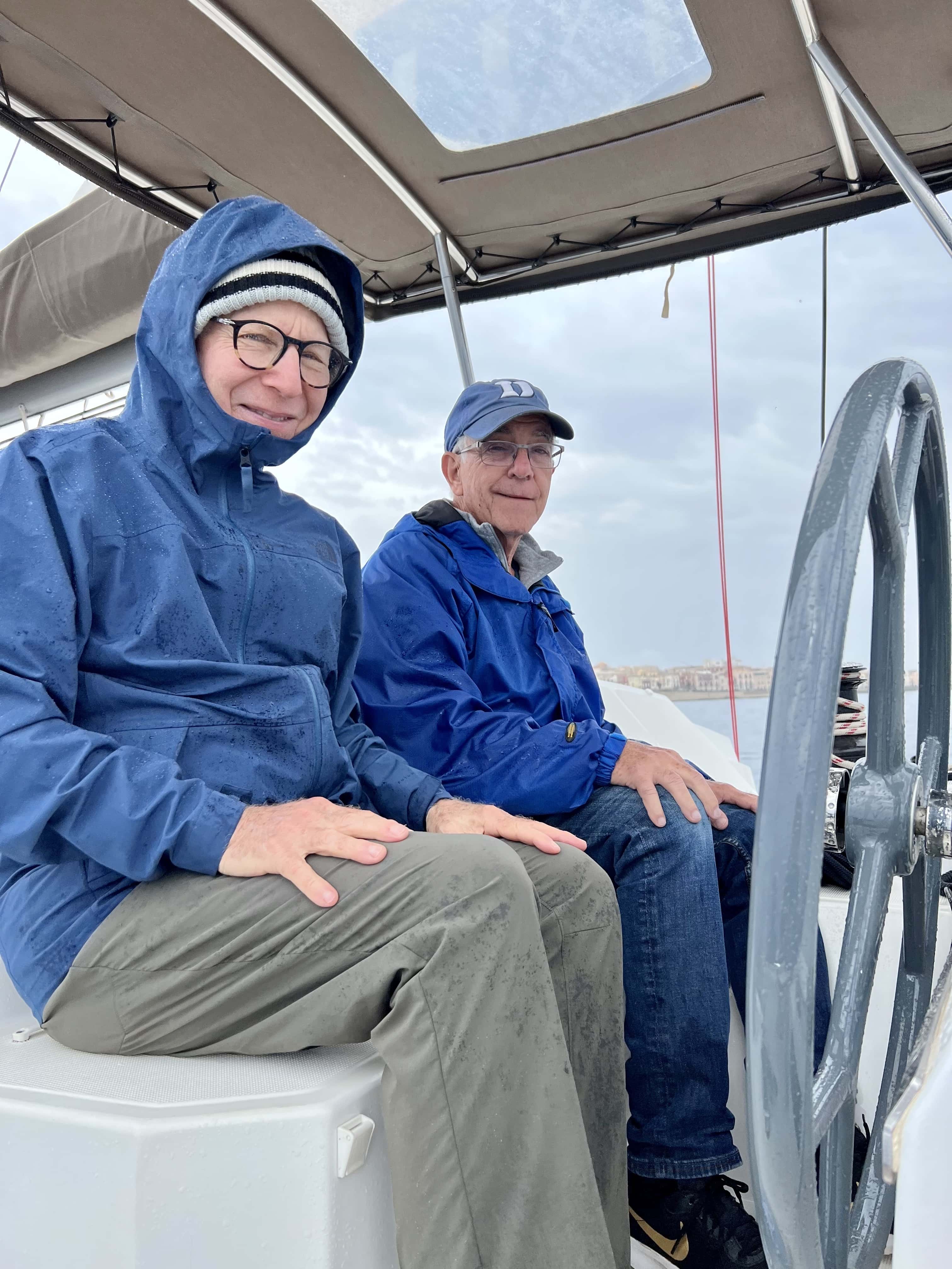 dad-boat-guys-in-rain – Sailing Sabática